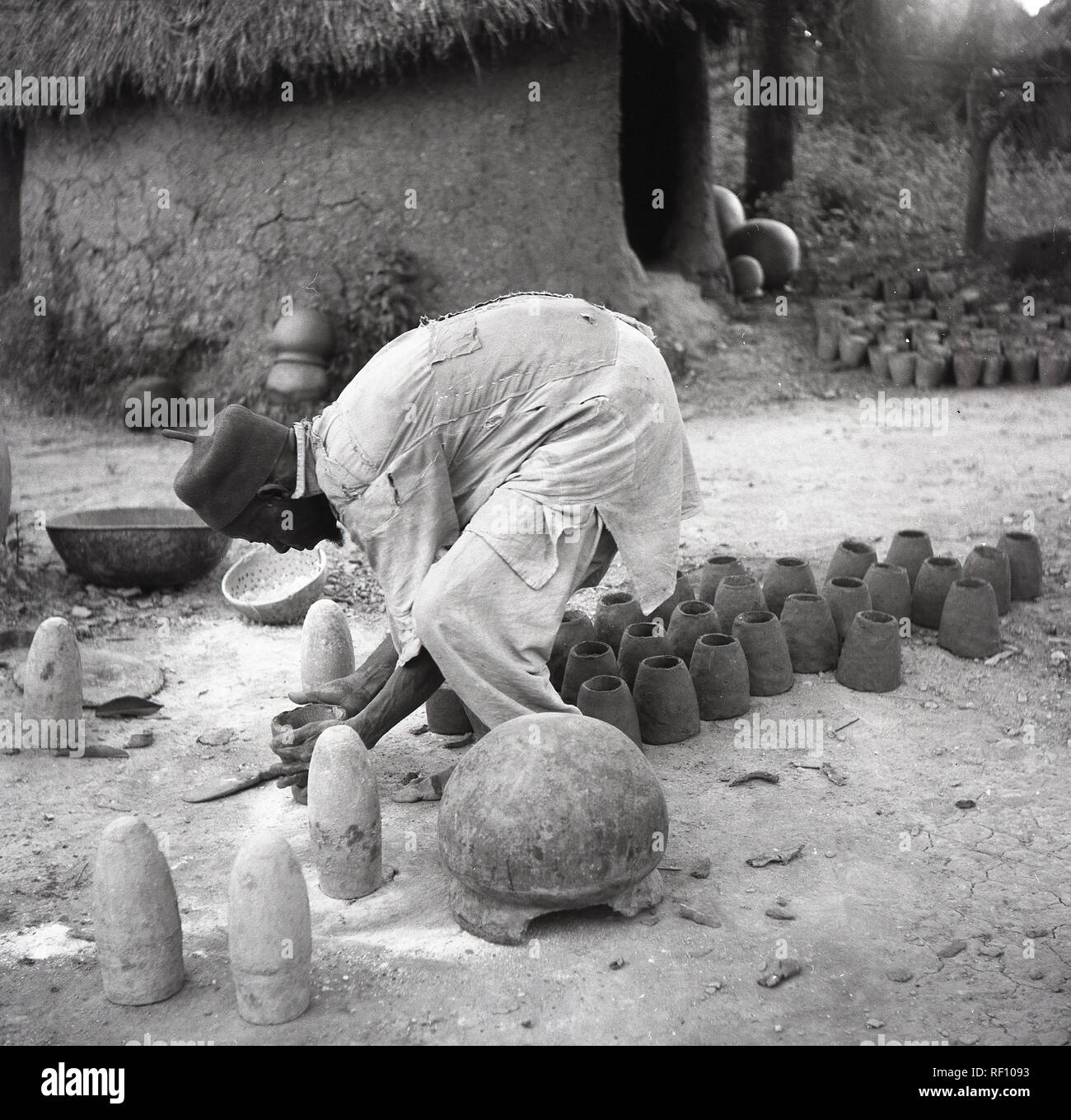 1950s, historical, local African wearing traditional Yoruba hat, an Aso ...