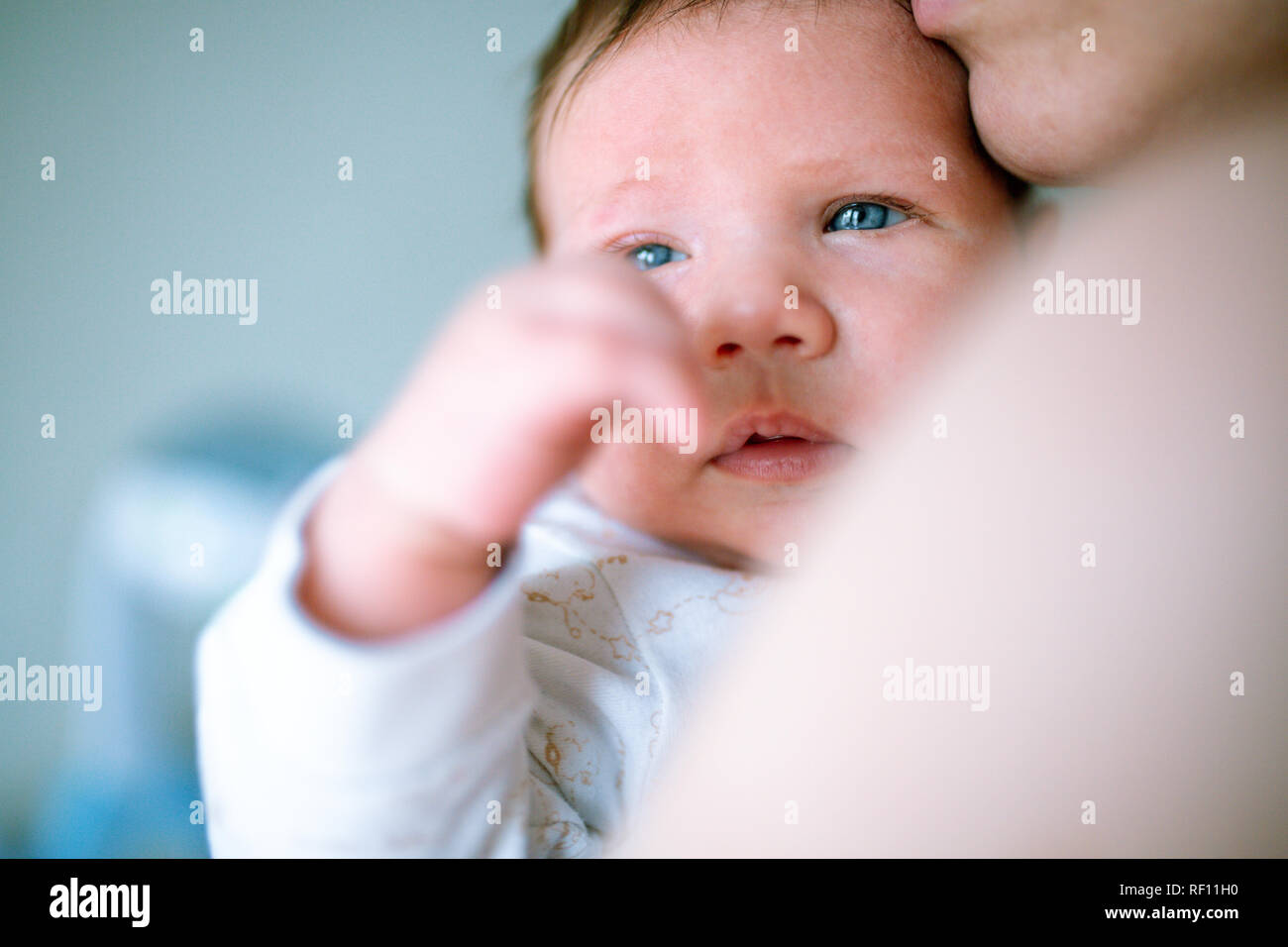Young mother hugging her newborn child. Mom nursing baby. Family at ...