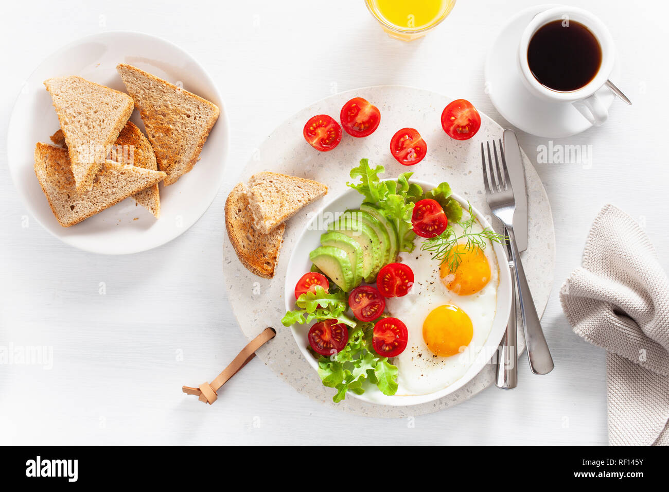 healthy breakfast flat lay. fried eggs, avocado, tomato, toasts Stock ...