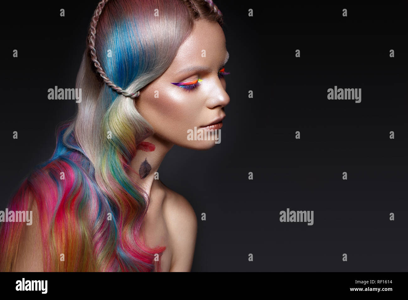 Beautiful girl with multi-colored hair and creative make-up and ...