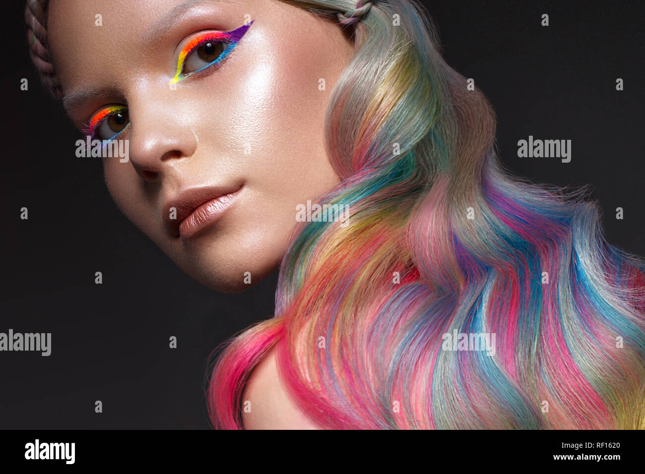 Beautiful girl with multi-colored hair and creative make-up and ...