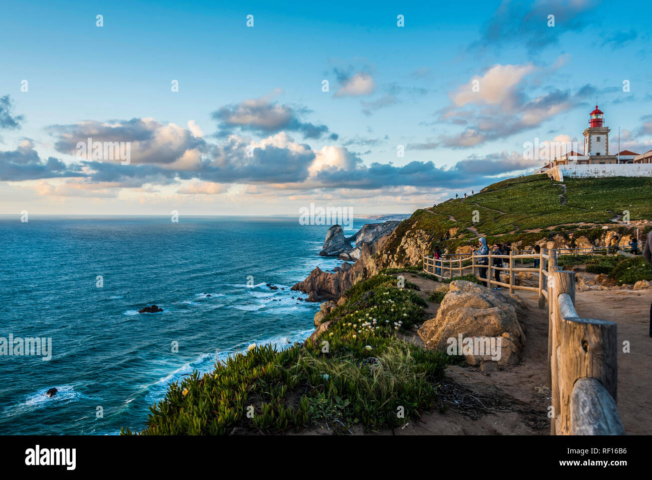 The Atlantic coast north of Cabo da Roca with its lighthouse at sunset ...