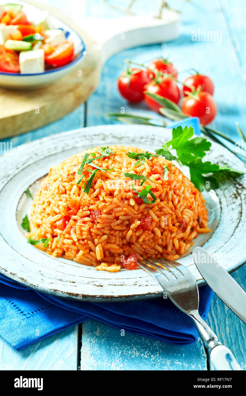 Serving of Greek tomato pilaf with long grained rice seasoned with ...