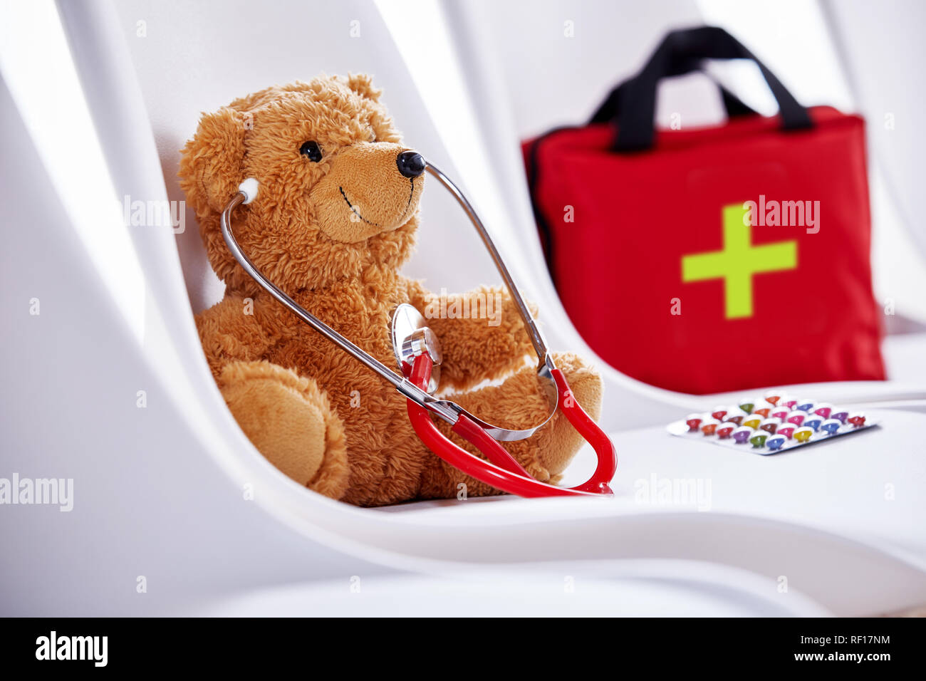 Medical concept of teddy bear with stethoscope sitting on chair with ...