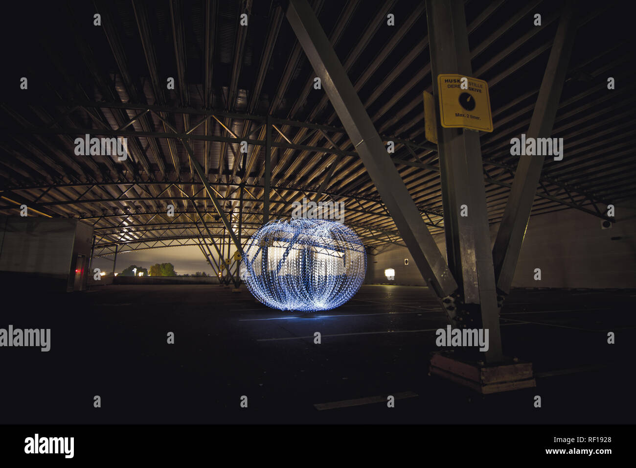 A creative person is creating a light ball in an industrial hall Stock ...