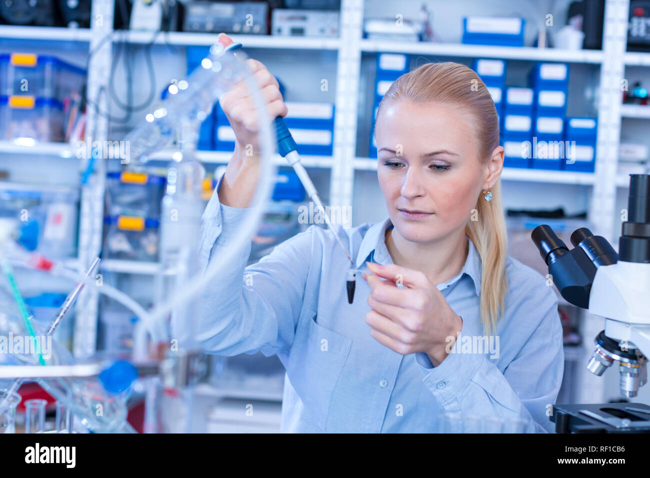 Female technician in laboratory of genetics - reprogenetics. Young ...
