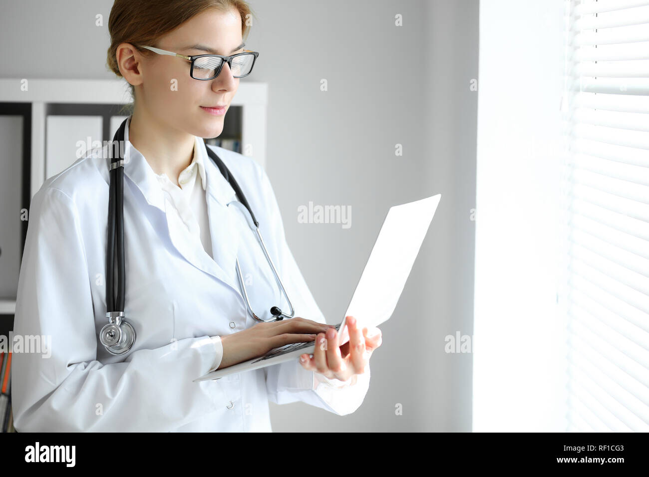 Doctor woman at work. Portrait of female physician at hospital office ...