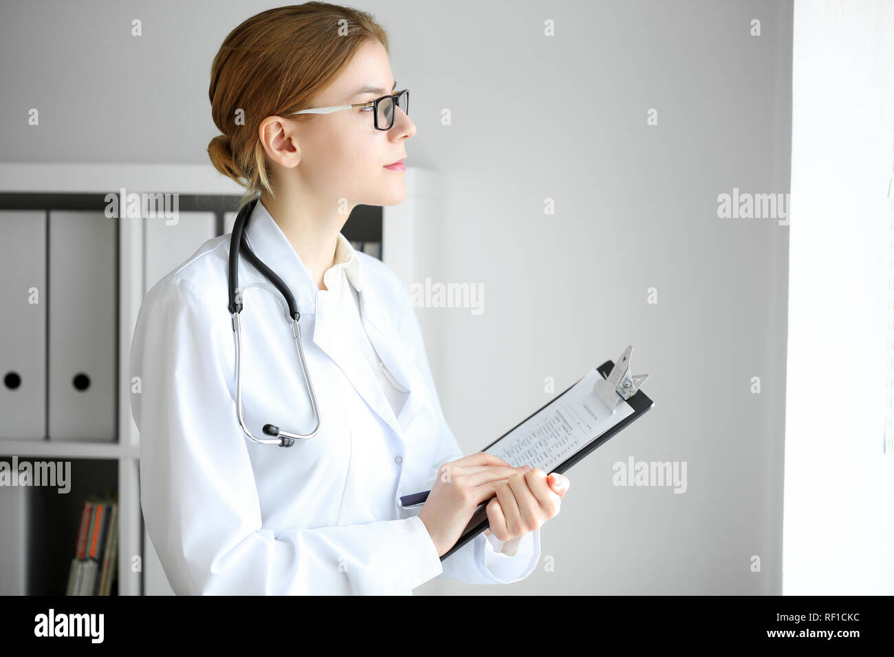 Doctor woman at work. Portrait of female physician at hospital office ...