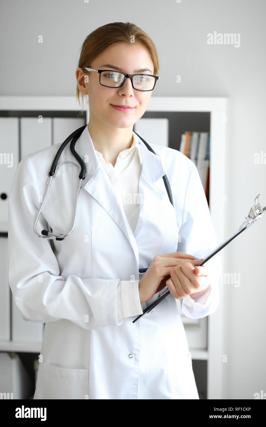Doctor woman at work. Portrait of female physician at hospital office ...