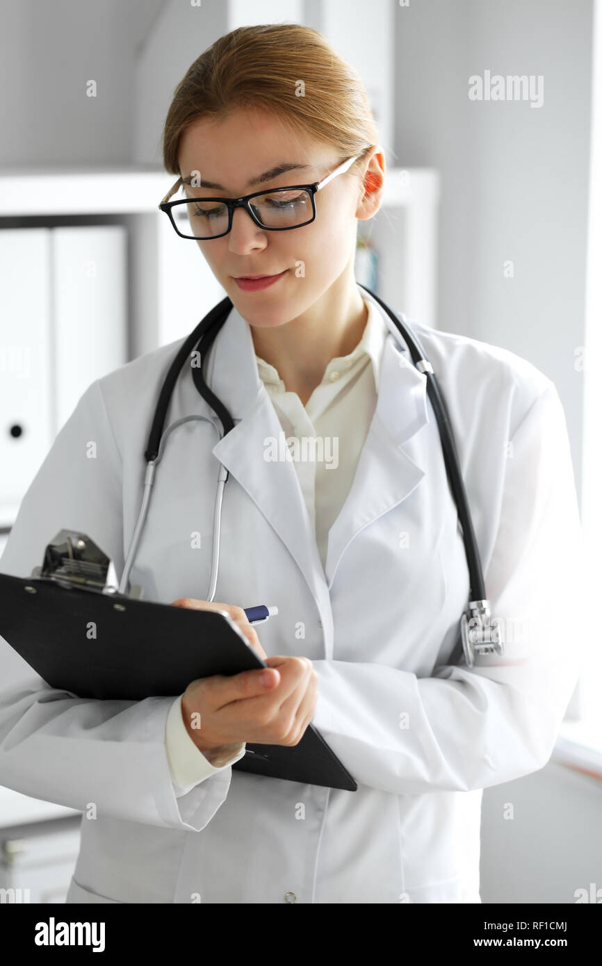 Doctor woman at work. Portrait of female physician at hospital office ...