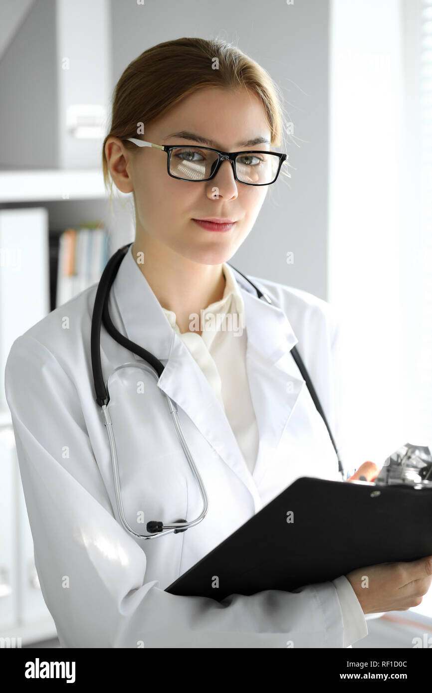 Doctor woman at work. Portrait of female physician at hospital office ...