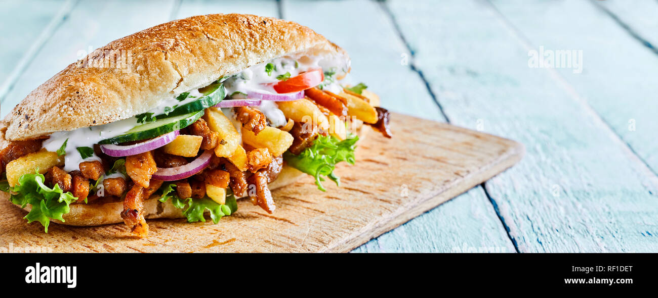 Greek gyros burger with roasted sliced kebab meat, french fries and ...