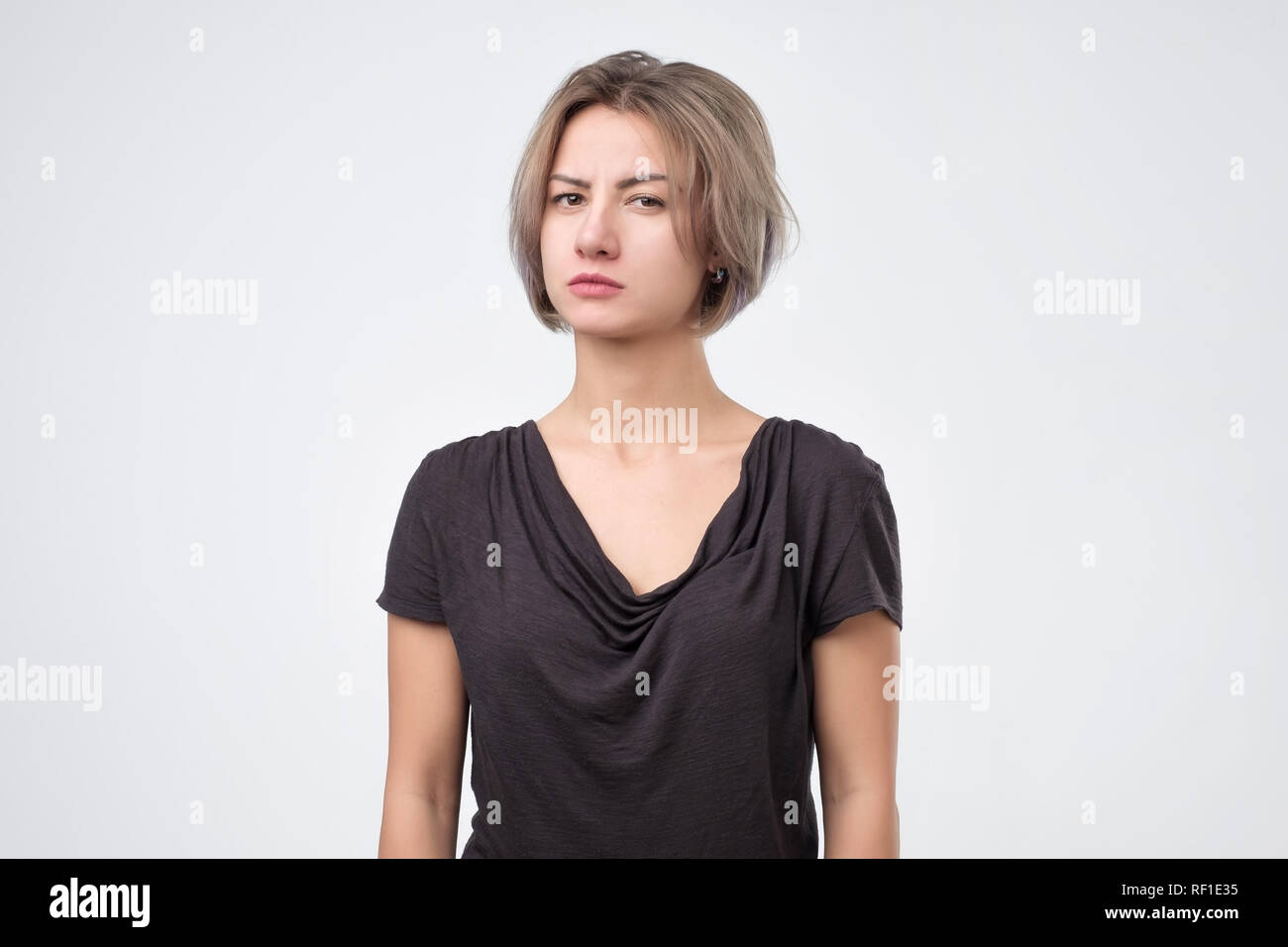 Sad woman serious and concerned looking worried and thoughtful facial ...