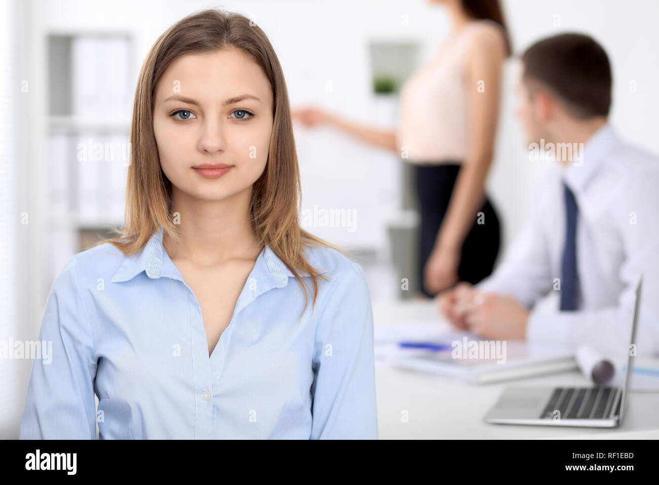 Portrait of a young business woman at meeting. Negotiation concept ...