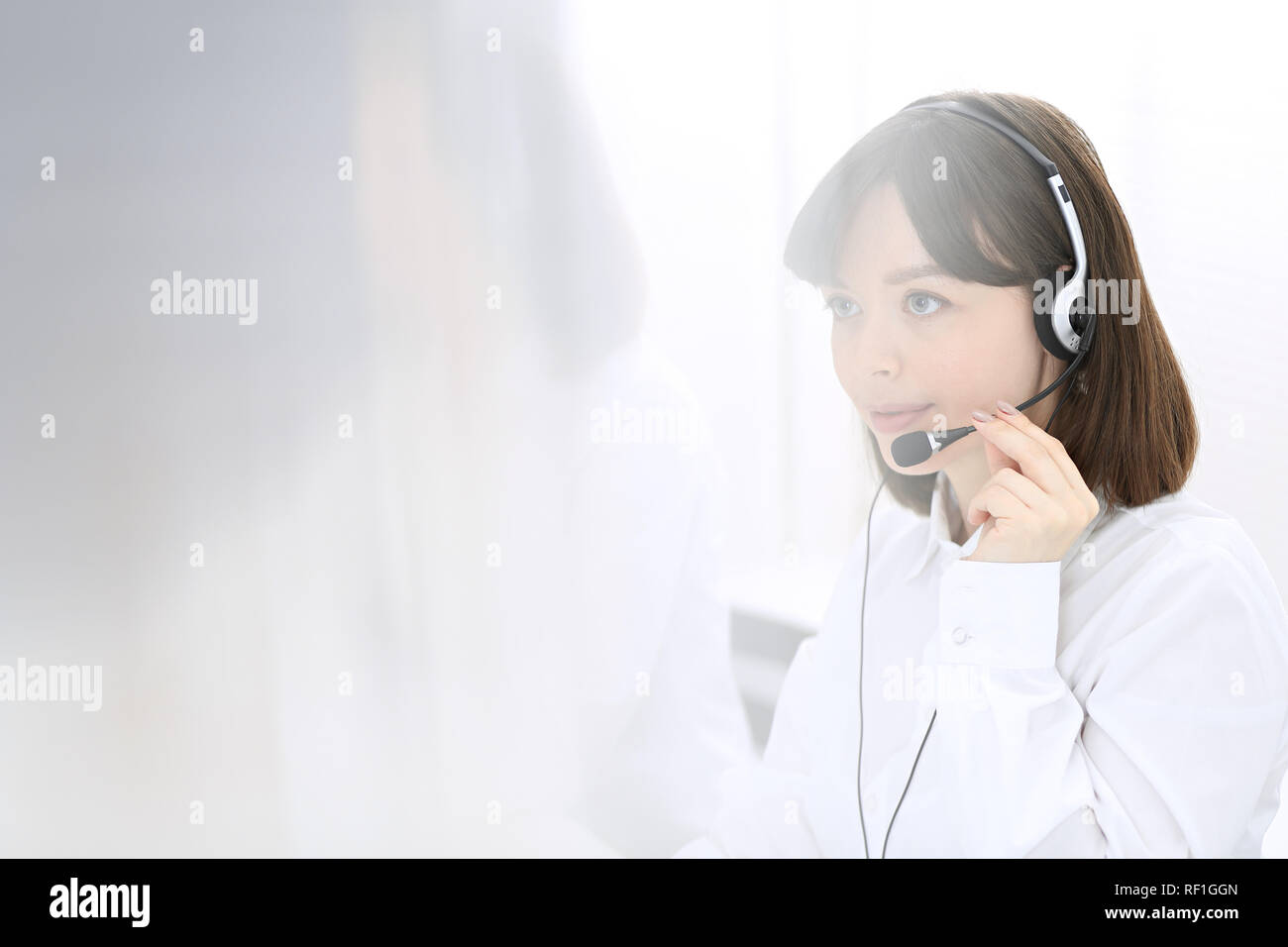 Call center. Group of operators at work. Focus on young brunette woman. Business concept Stock ...