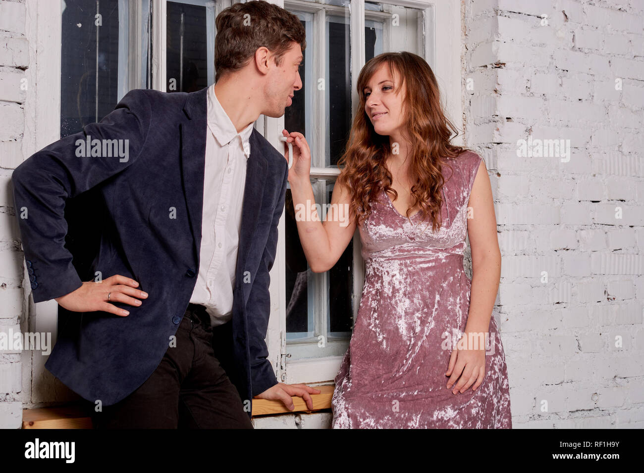 a loving couple stands by the window and hugs Stock Photo - Alamy