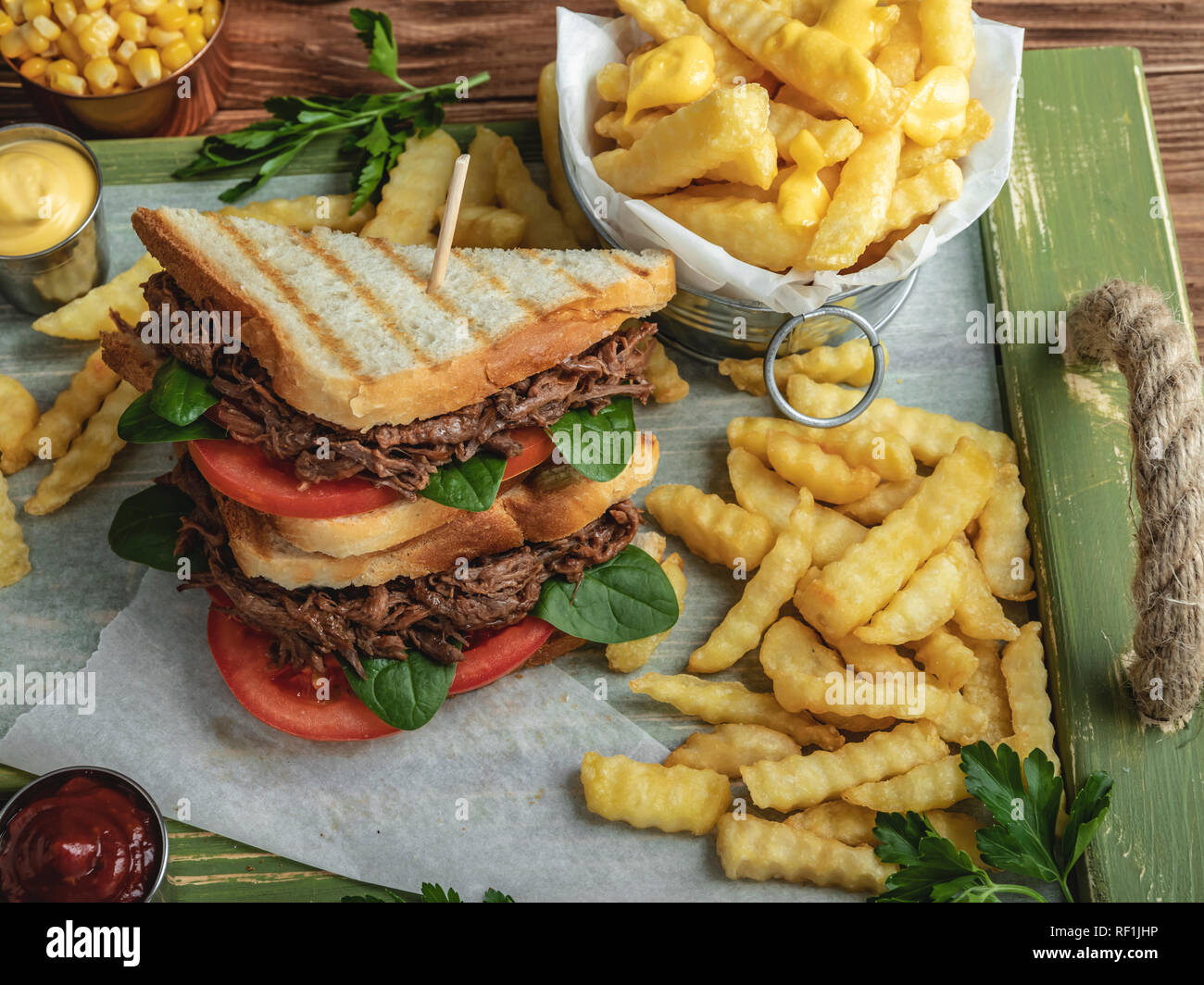 Beef sandwich pulled , barbeque, toast, french fries, sauce, corn on a ...