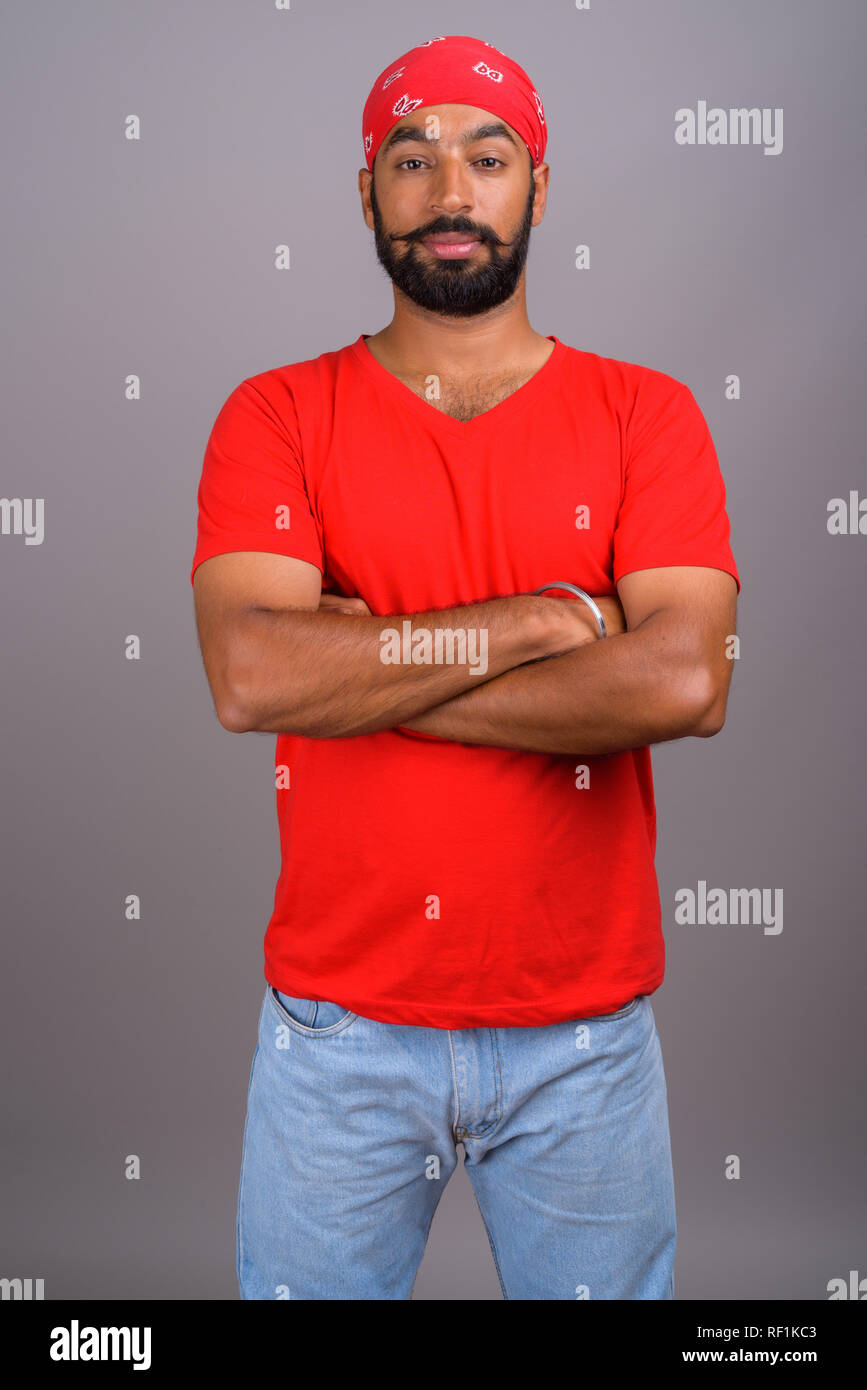 Portrait of young handsome Indian man wearing red shirt Stock Photo - Alamy