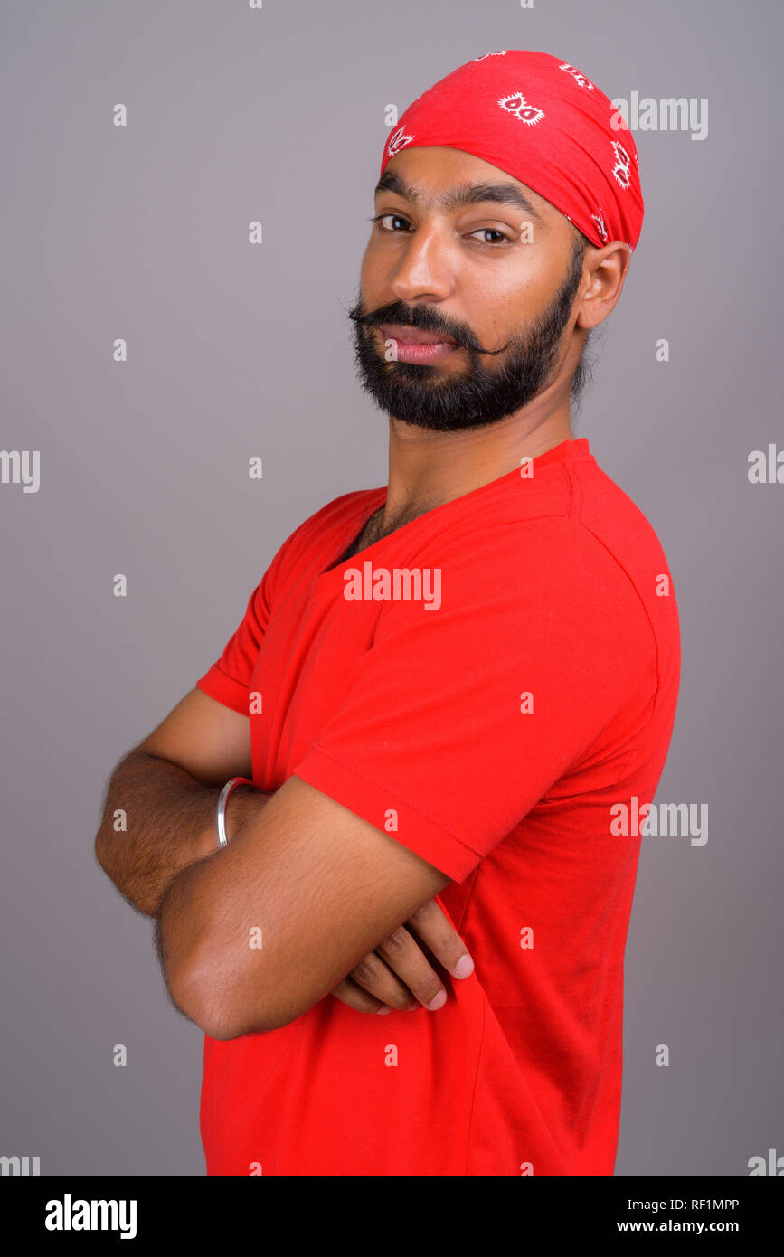Portrait of young handsome Indian man wearing red shirt Stock Photo - Alamy