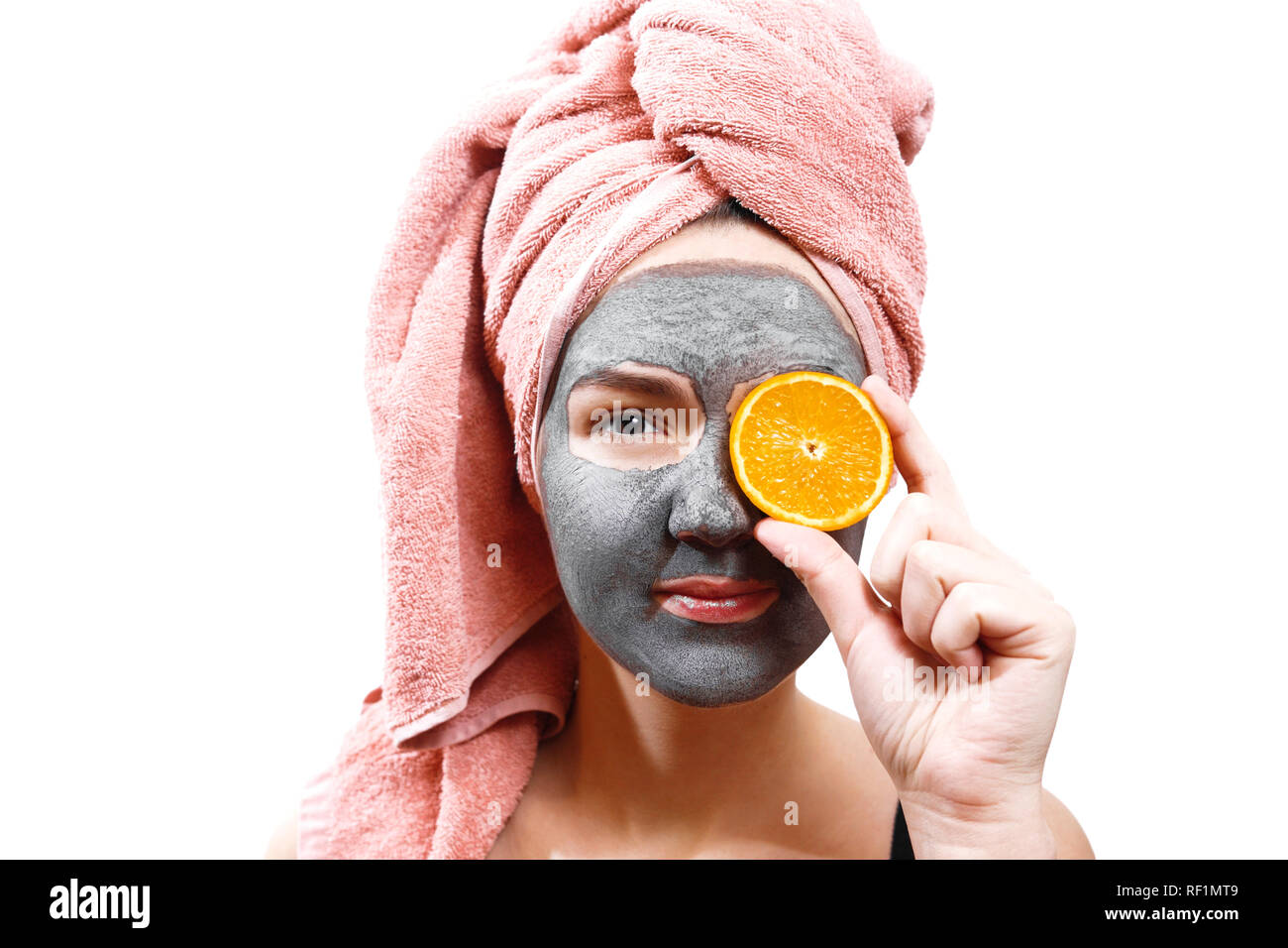 young woman in mask for face skin with orange on isolated white ...