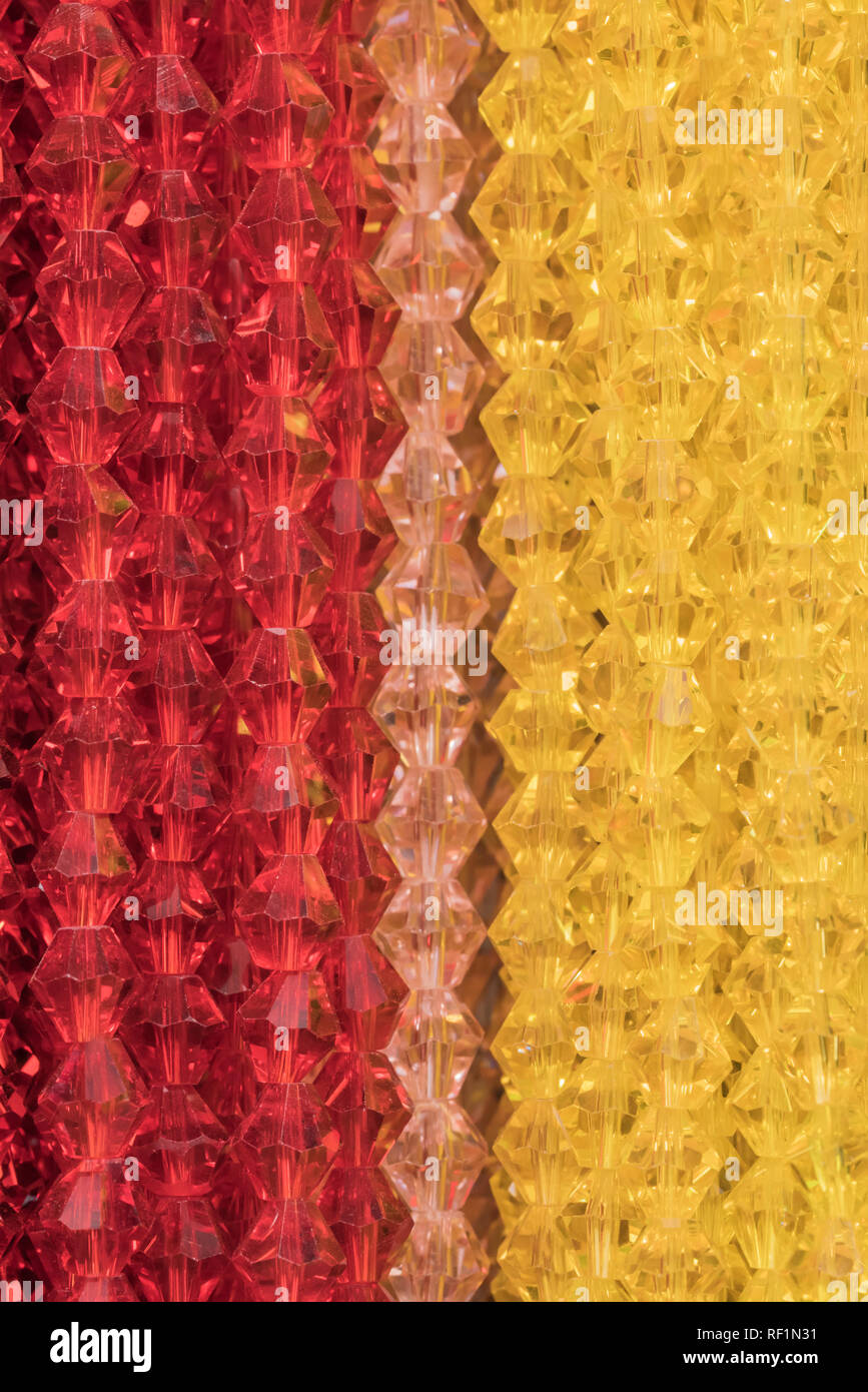 Cutout texture closeup on multiple transparent red and yellow diamond ...