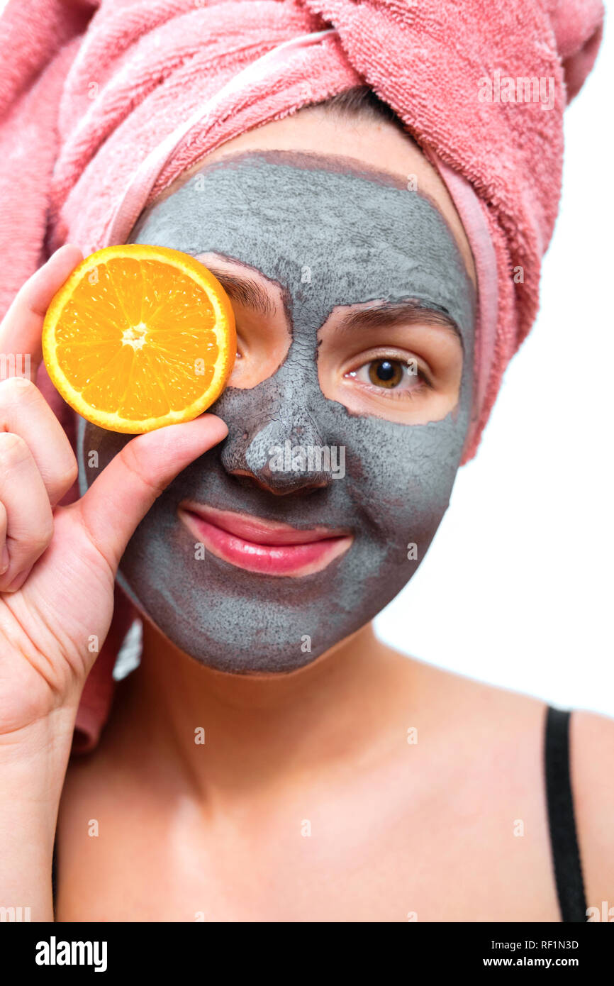 young woman in mask for face skin with orange on isolated white ...