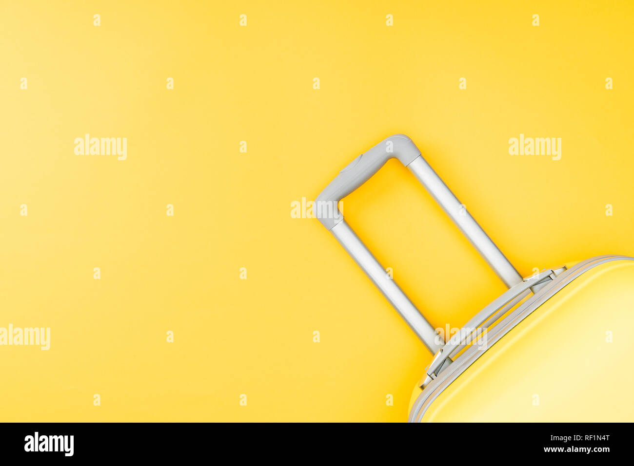 top view of baggage with handle on yellow background Stock Photo - Alamy