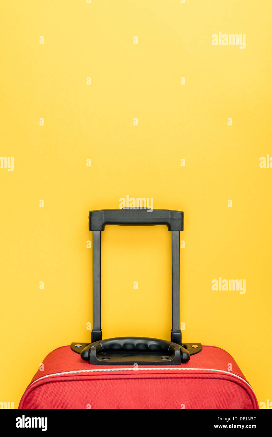 top view of red baggage with handle on yellow background Stock Photo ...