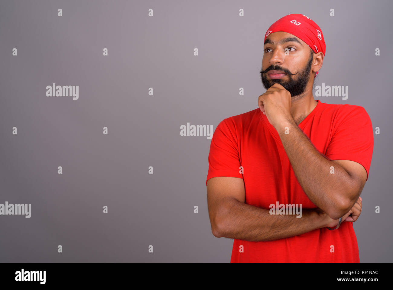 Portrait of young handsome Indian man thinking Stock Photo - Alamy