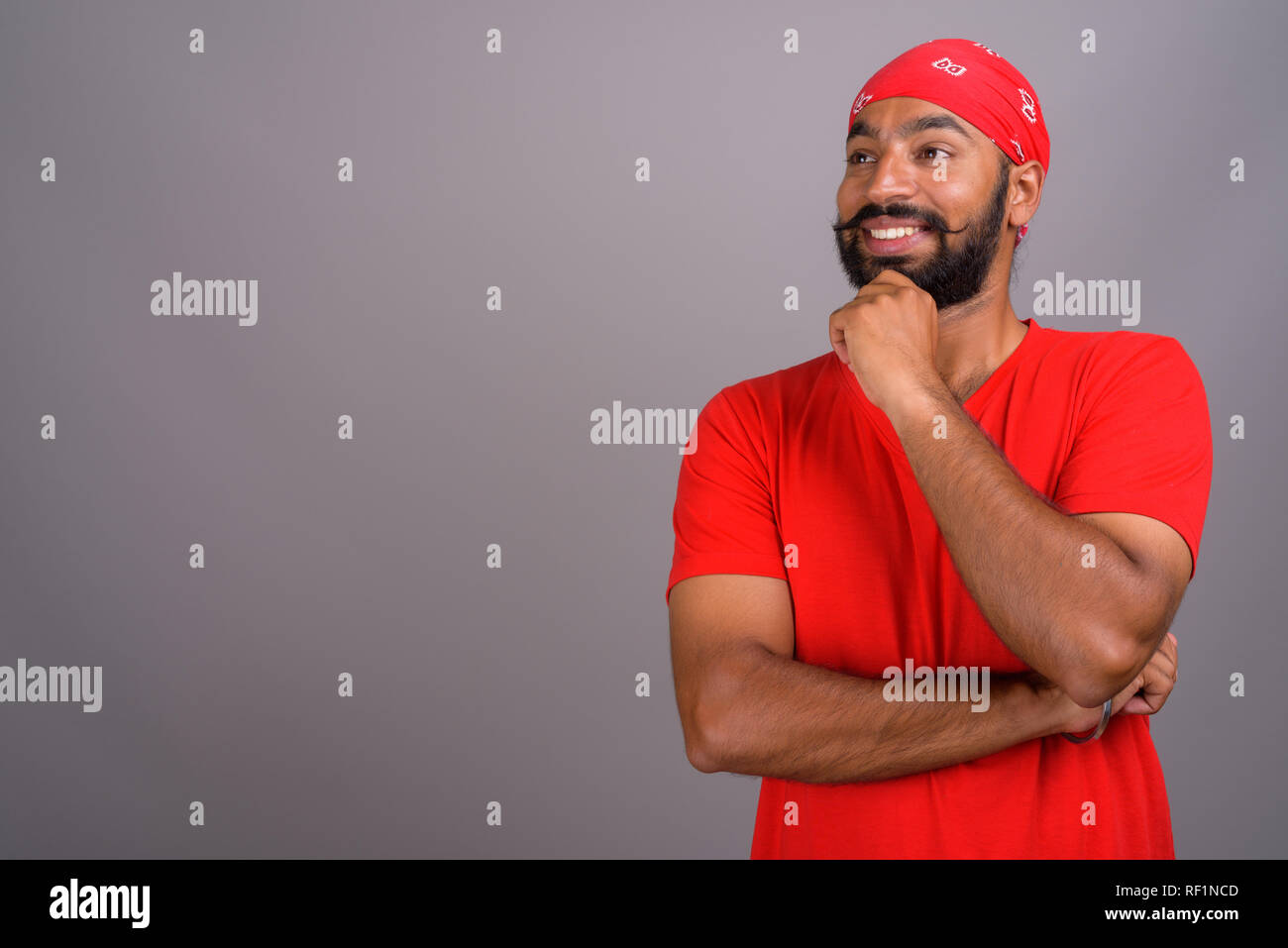 Portrait of young handsome Indian man thinking Stock Photo - Alamy