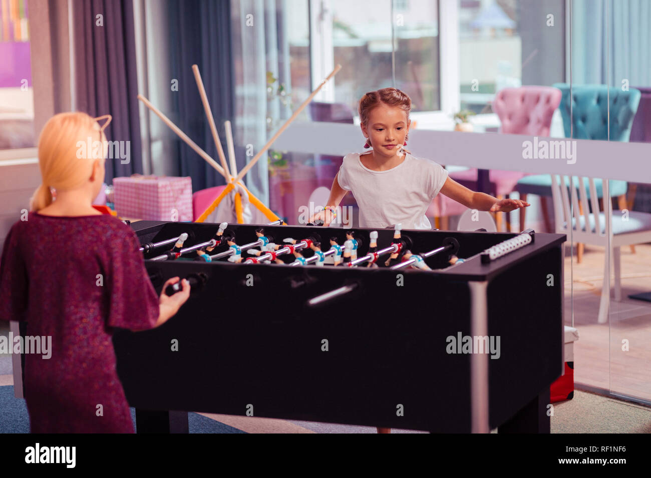 Two pretty girls playing table game together Stock Photo - Alamy