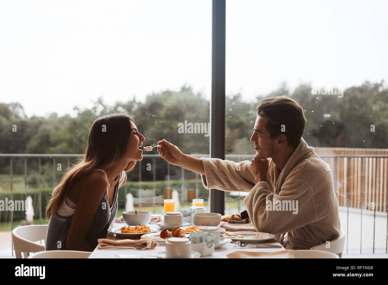 Romantic couple eating breakfast together at the hotel Stock Photo - Alamy