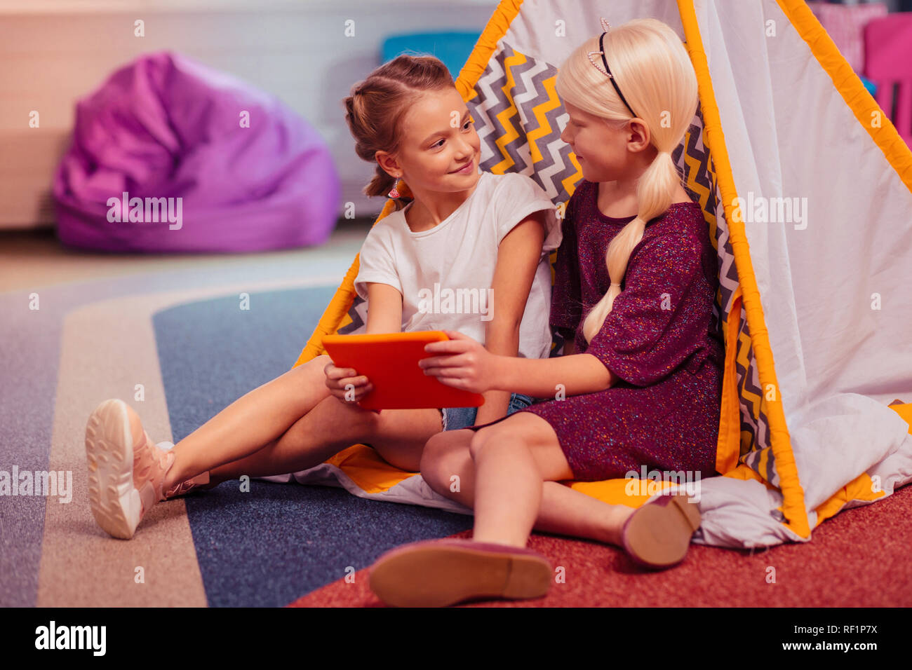 Two pretty friends resting together in tent Stock Photo - Alamy