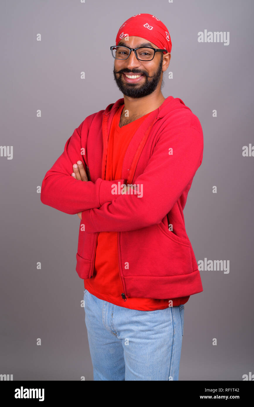 Portrait of young handsome Indian man wearing red shirt Stock Photo - Alamy