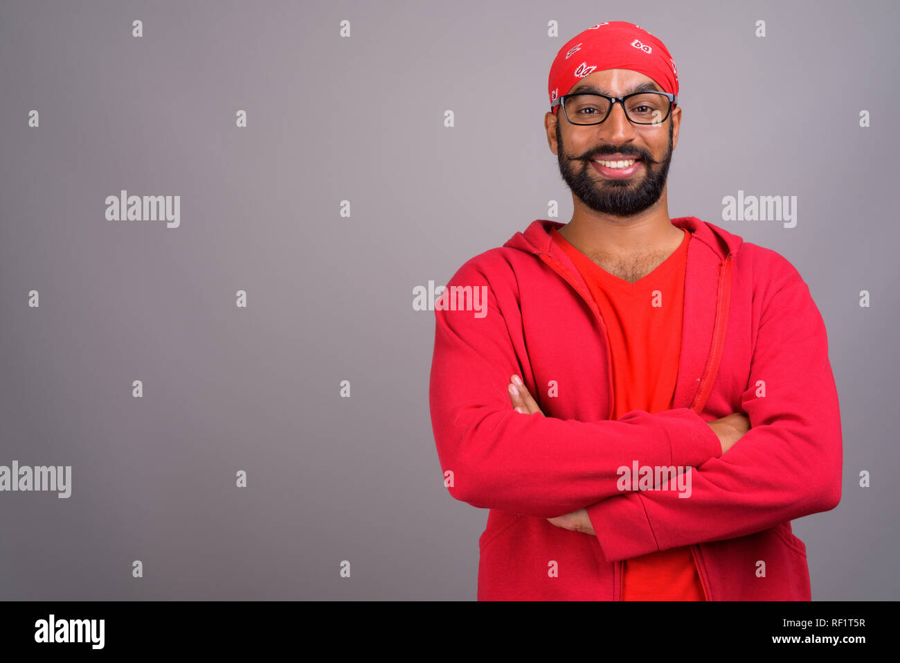 Portrait of young handsome Indian man wearing red shirt Stock Photo - Alamy
