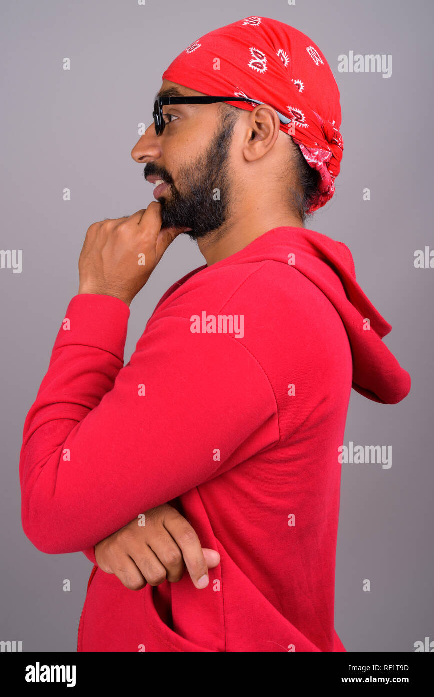 Profile view of young handsome Indian man thinking Stock Photo - Alamy