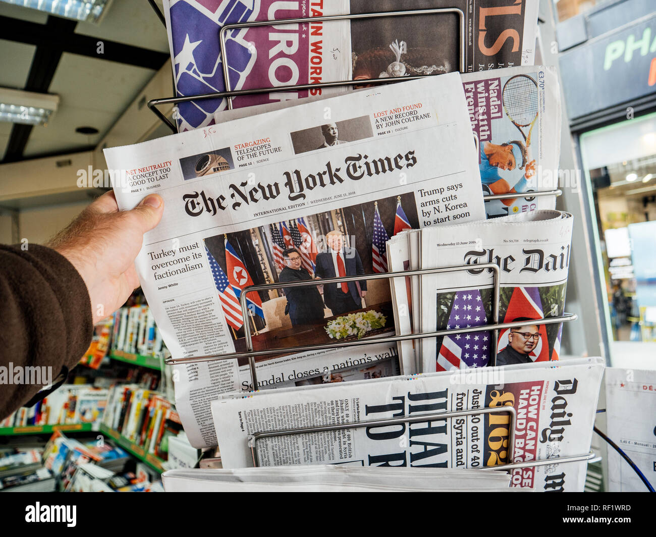 PARIS, FRANCE - JUNE 13, 2018: Man buying The New York Times newspaper ...