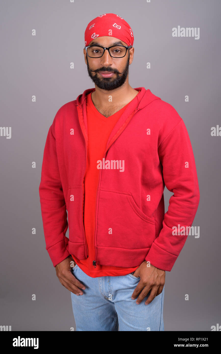 Portrait of young handsome Indian man wearing red shirt Stock Photo - Alamy