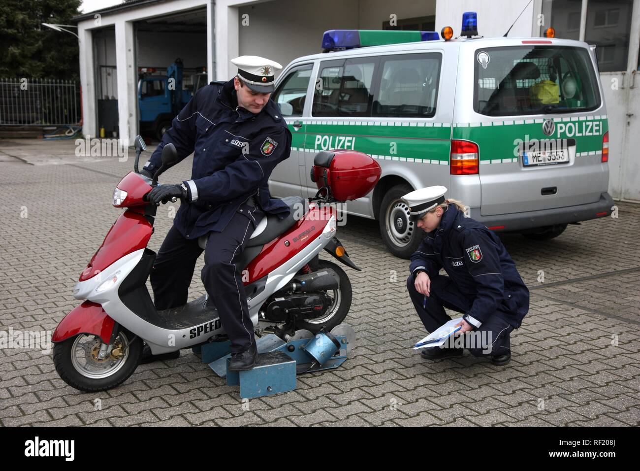 Police officers checking a small moped that has been manipulated and ...