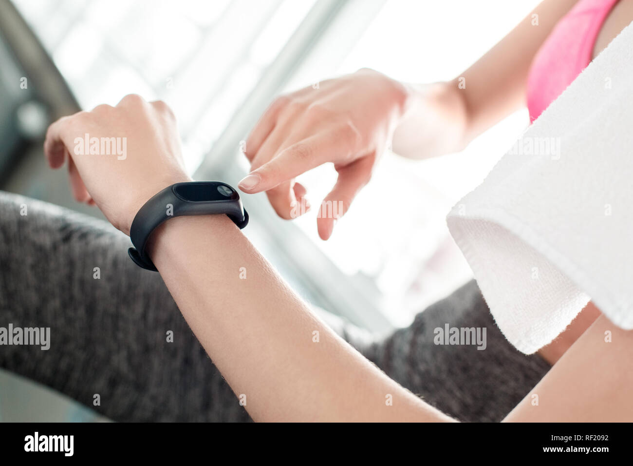 Young girl in gym healthy lifestyle sitting checking information on ...