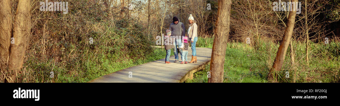 Happy family speaking and playing together in the forest Stock Photo ...