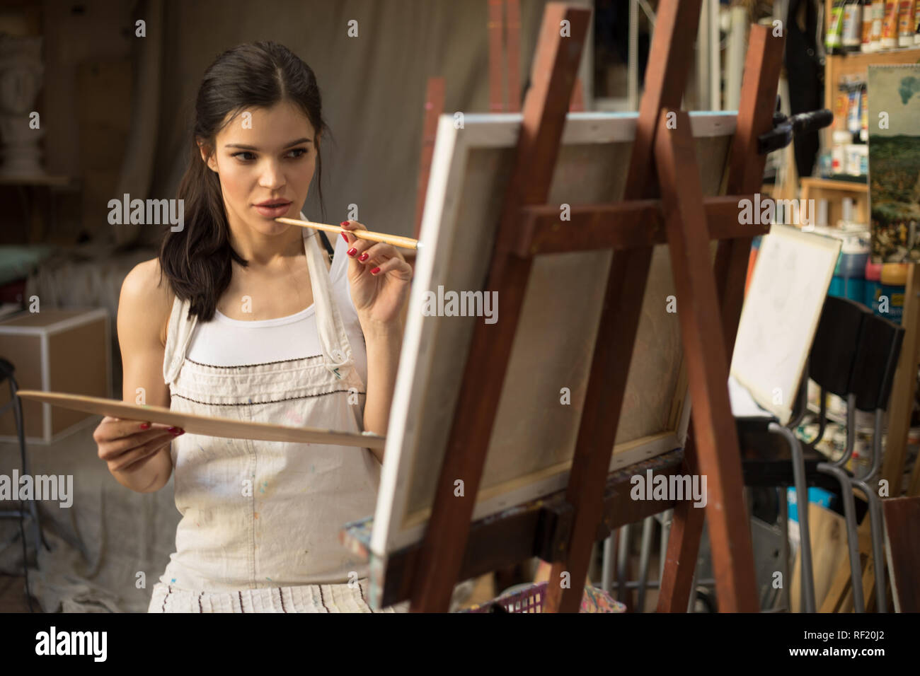 Professional Woman artist painting picture in art studio Stock Photo ...