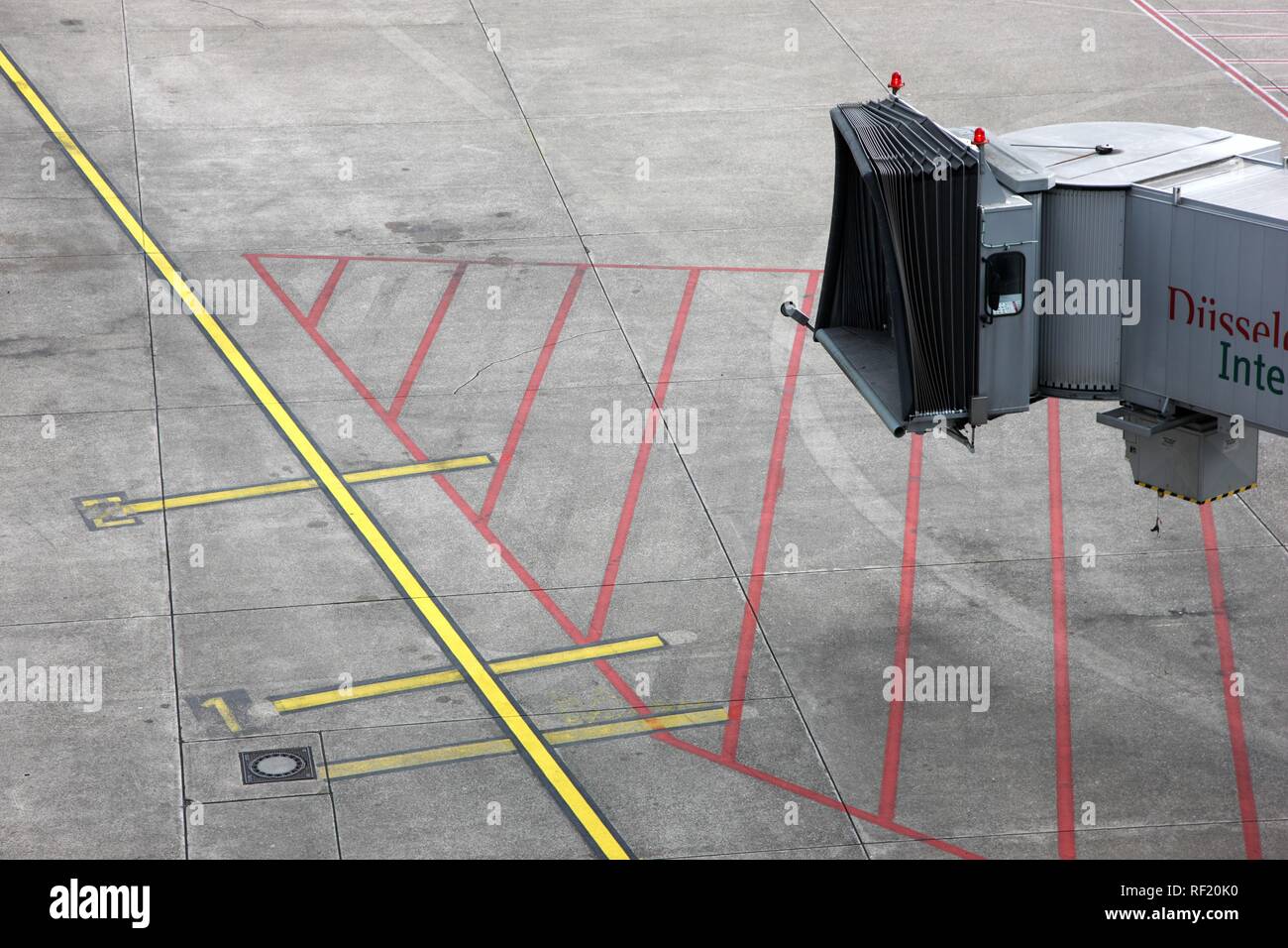 Passenger bridge, wing and parking markers for planes on the apron ...