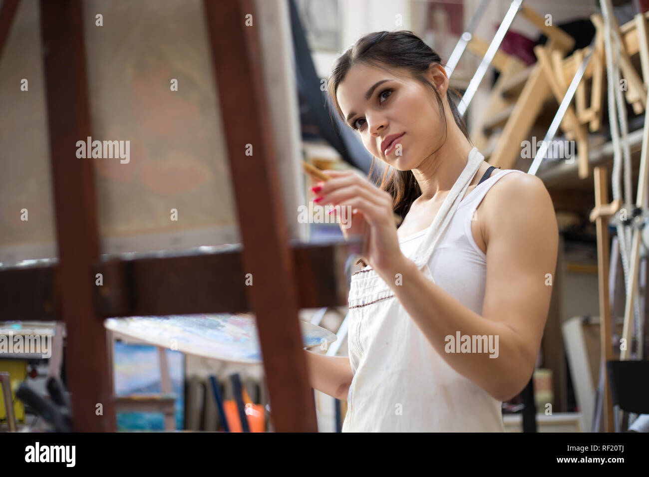 Professional Woman artist painting picture in art studio Stock Photo ...