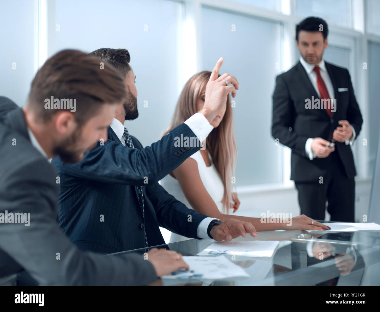 employee at the presentation raise their hands to ask a question Stock ...