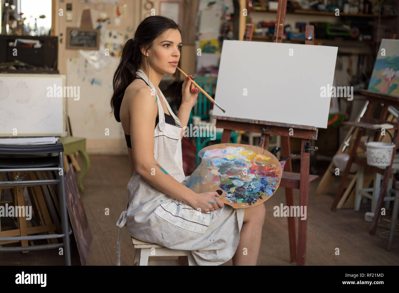 Professional Woman artist painting picture in art studio Stock Photo ...