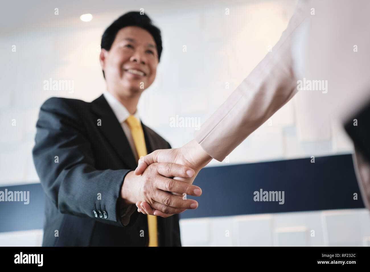 Handshake Between Happy Asian Manager And Hispanic Businesswoman In ...