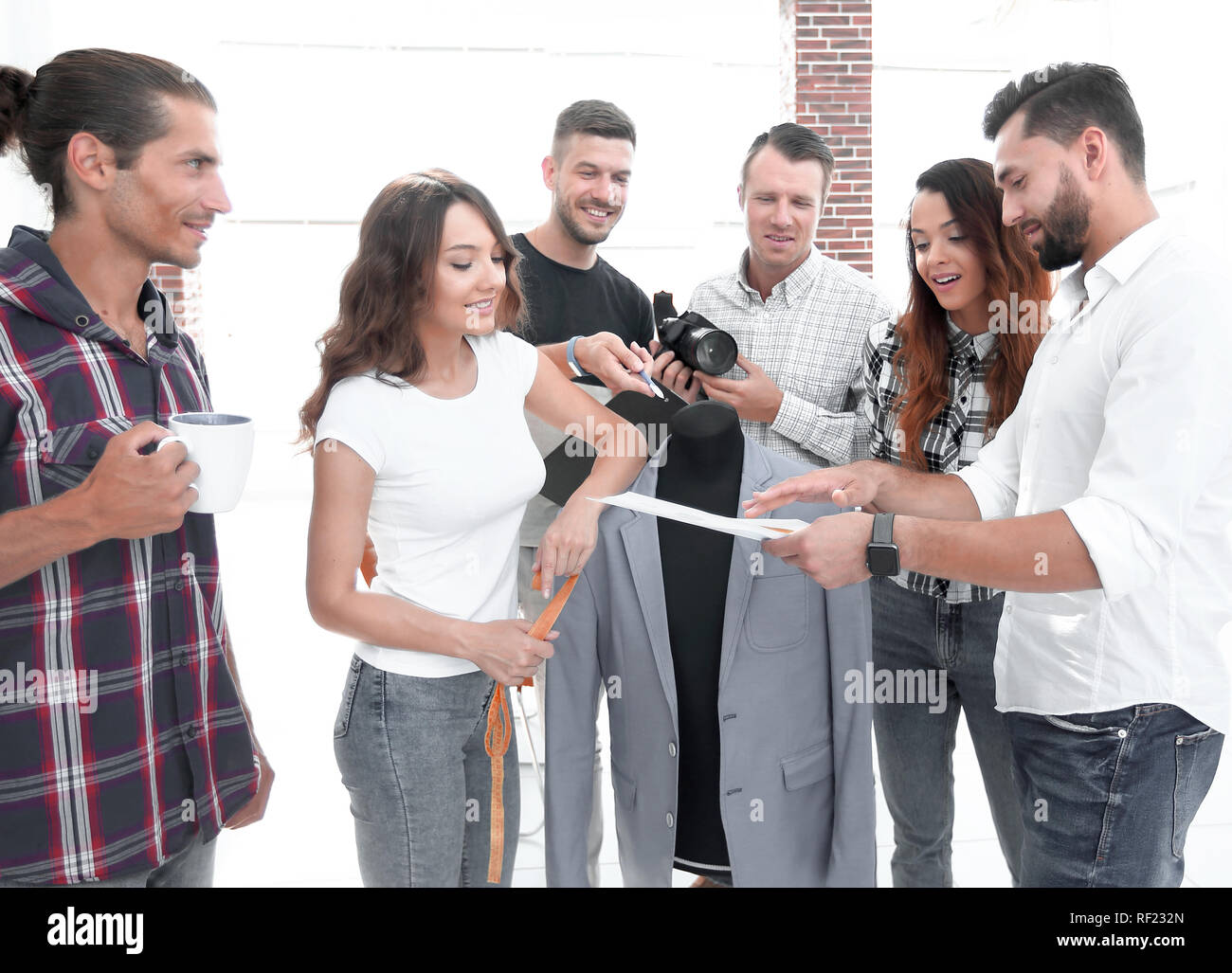 designers working with new models of men's clothing Stock Photo - Alamy