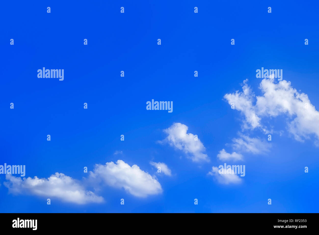 a bright blue sky with clouds background Stock Photo - Alamy