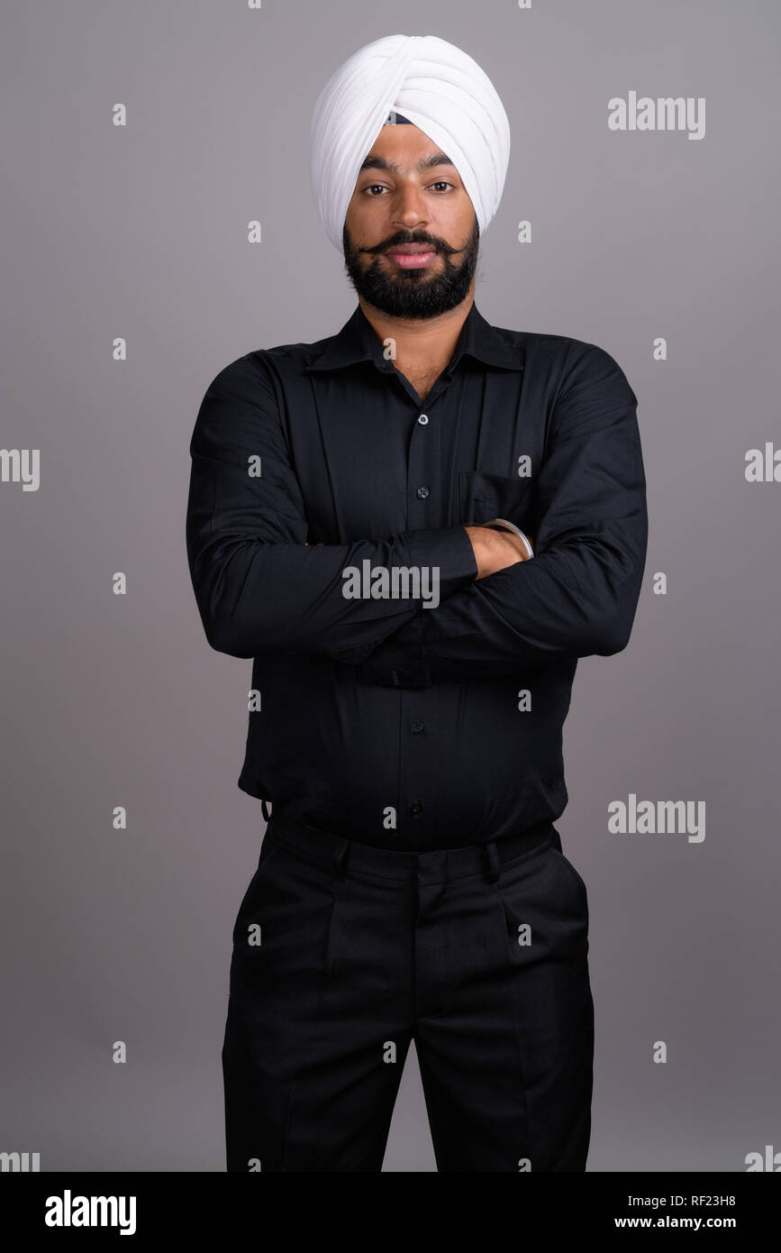 Young Indian Sikh businessman wearing white turban Stock Photo - Alamy
